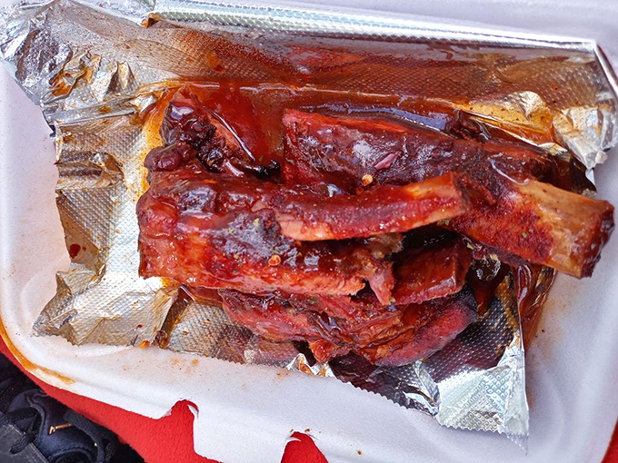 These ribs glisten with a sauce so hypnotic you'll momentarily forget about the napkin situation until it's far too late for your shirt.