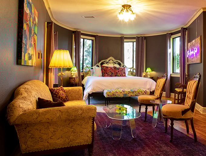 This bedroom suite wraps you in dramatic sophistication with its curved walls, jewel-toned carpet, and enough windows to make vitamin D deficiency impossible.