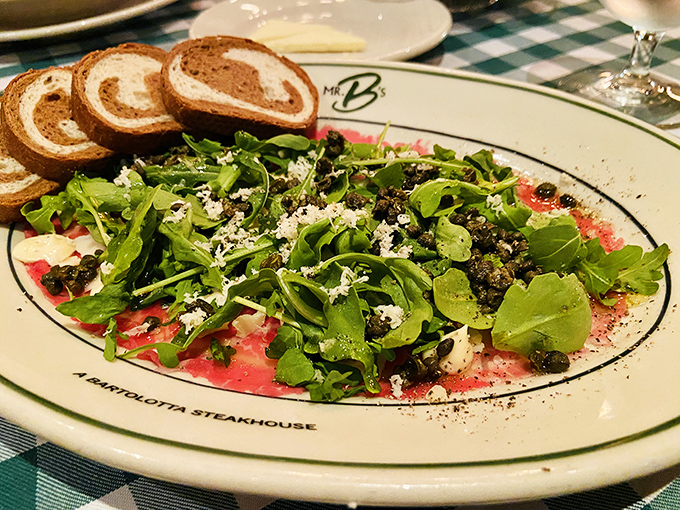 This carpaccio isn't just thinly sliced beef&mdash;it's a canvas where peppery arugula and sharp cheese create edible art that Picasso would envy.