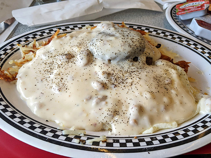 Beneath that pepper-speckled blanket of country gravy lies a breakfast that could fuel a farmhand&mdash;or just you on a lazy Sunday.