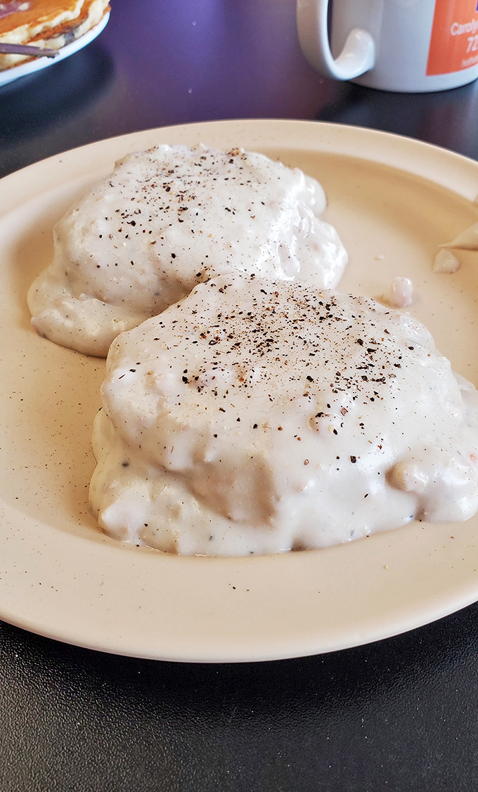 Biscuits and gravy that could make a Southern grandmother nod in approval. Pepper-speckled cream gravy blankets these beauties like a warm hug.