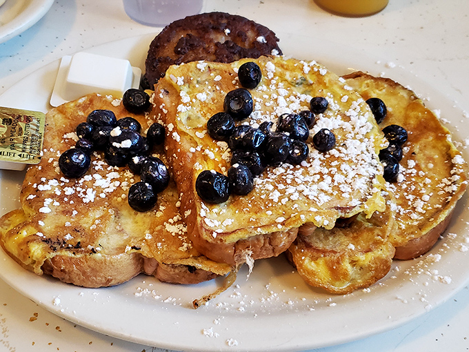 French toast that turns breakfast into dessert without apology, where blueberries and powdered sugar create edible artwork.