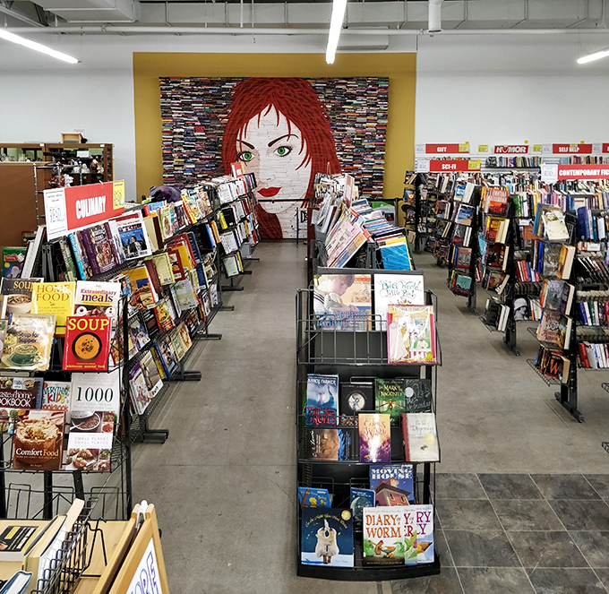The book department, where that hypnotic red-haired mural watches over literary treasures ranging from dog-eared paperbacks to leather-bound classics.