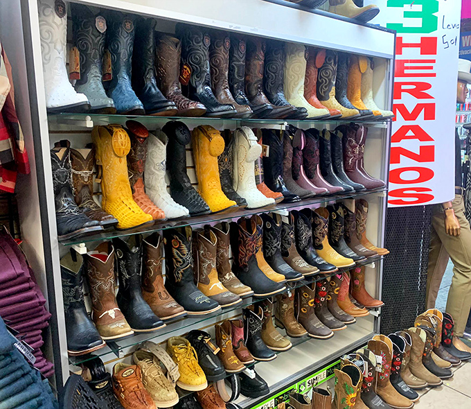 Cowboy boots in every color of the rainbow, proving that somewhere, someone needs purple snakeskin footwear.