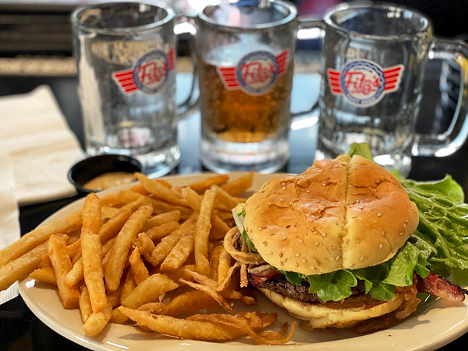 A burger that demands both hands and several napkins, paired with Fitz's signature sodas in branded mugs—a match made in comfort food heaven.