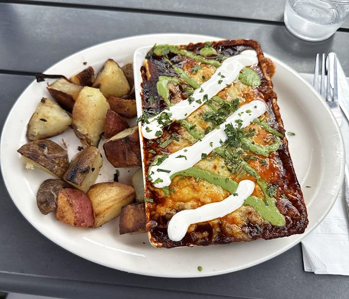 A breakfast creation that defies gravity and expectations—roasted potatoes standing guard beside what might be Cleveland's most photogenic morning meal.