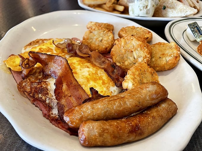 The breakfast platter that answers all life's important questions: crispy bacon or juicy sausage? Why not both, with eggs and hash browns?
