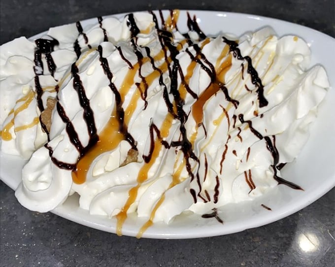 This mountain of whipped cream, drizzled with chocolate and caramel, isn't just dessert&mdash;it's performance art that happens to be delicious.