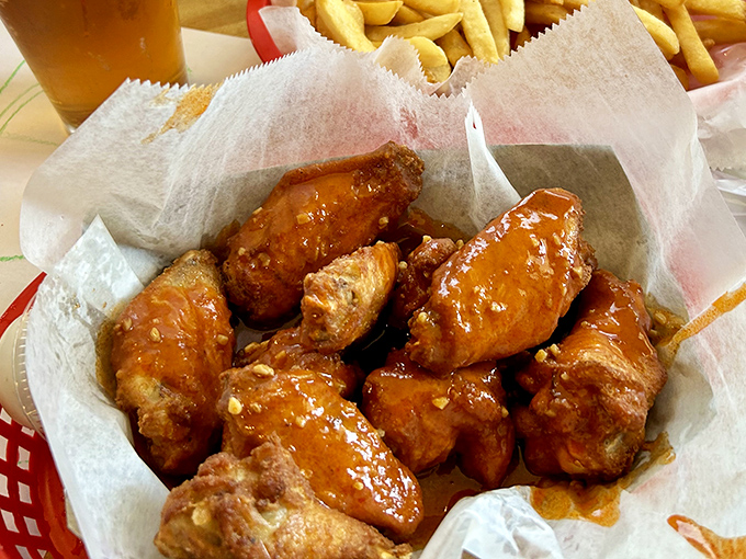 Buffalo wings glistening with sauce that promises a flavor explosion &ndash; these aren't just wings, they're little drums of joy playing a spicy symphony.