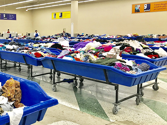 Rolling bins create shopping highways where fashion adventures begin with every colorful discovery.