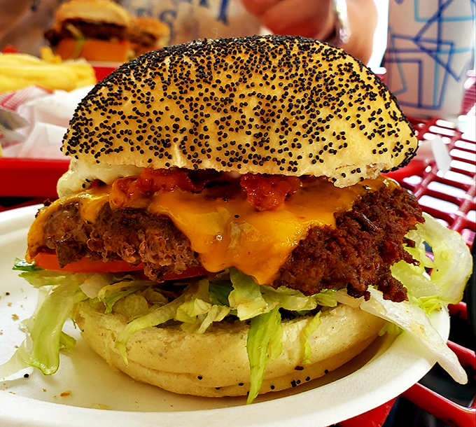 The Bunny Burger with its poppy seed crown sits like royalty on its throne of lettuce, challenging you to maintain dignity while devouring it.