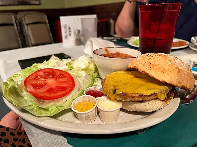 The burger arrives like a beautiful meat monument, with condiments standing at attention in their little cups, ready for deployment.