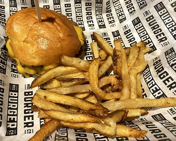 A cheeseburger and fries presented with honest simplicity. No pretentious vertical stacking here&mdash;just horizontal happiness waiting to be devoured.