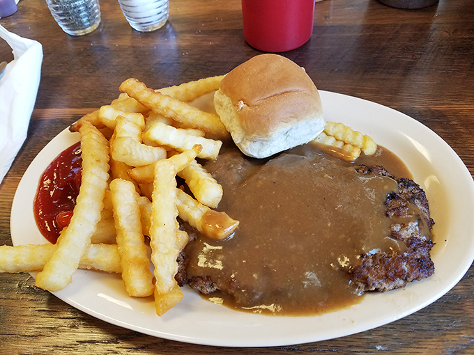 Hamburger steak swimming in rich gravy with a side of crispy fries&mdash;the kind of plate that makes you want to write thank-you notes to whoever invented the cow.