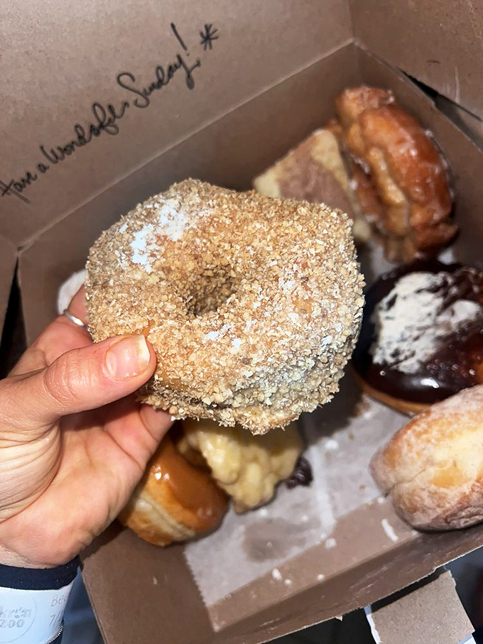 This crunch donut isn't just holding its hand up&mdash;it's waving you over to experience its golden-fried perfection.