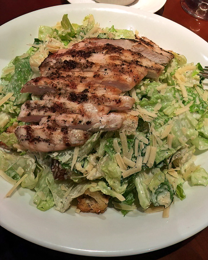 Caesar salad topped with grilled chicken&mdash;the dish that launched a thousand diets. Crisp romaine and savory protein in perfect harmony.