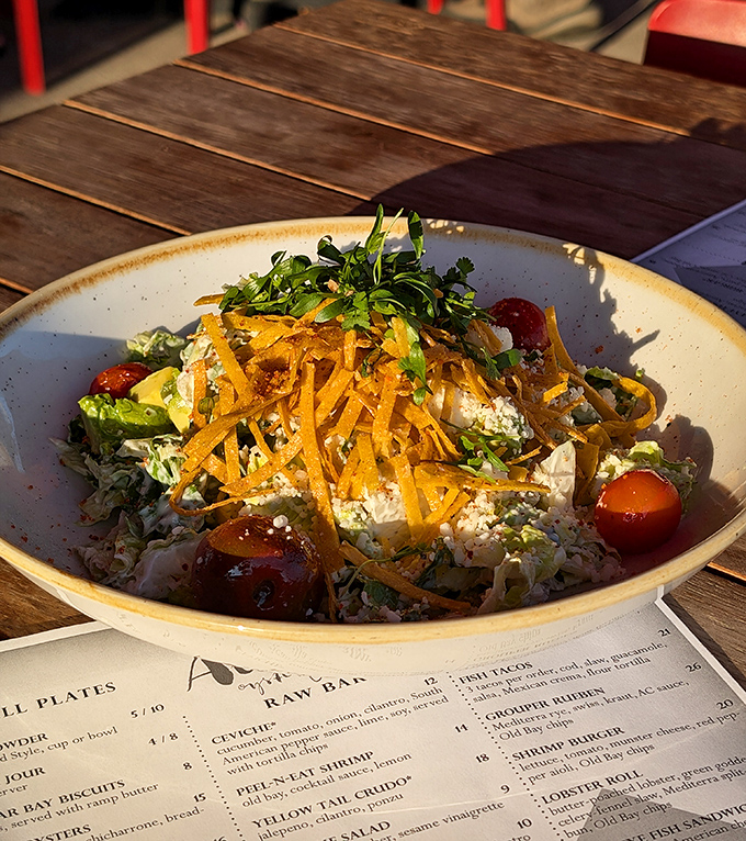 A salad that actually deserves to be ordered instead of just tolerated. Those shaved carrots on top aren't decoration&mdash;they're commitment to craft.