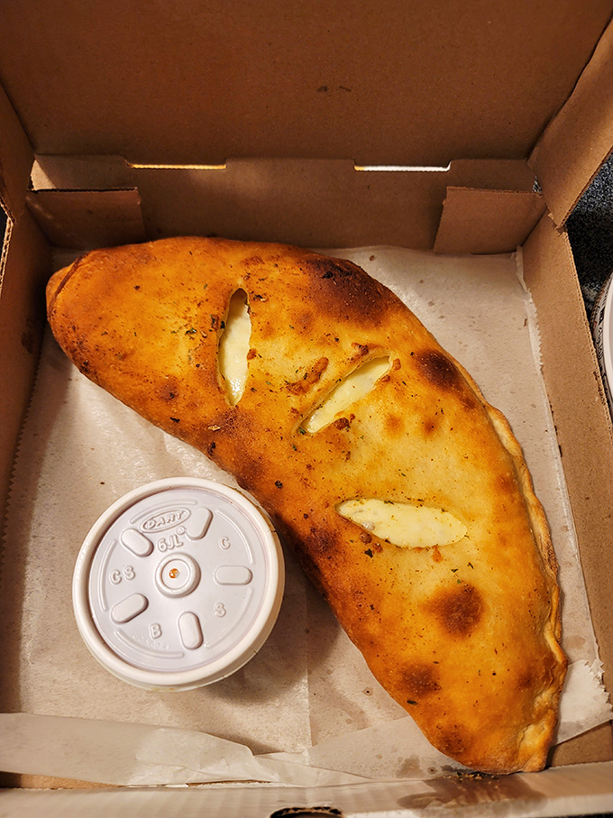 Behold the calzone that requires both hands and possibly a game plan for optimal enjoyment.