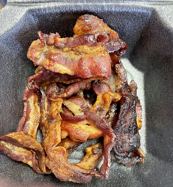 Candied bacon strips that look like they escaped from a Tim Burton cookbook, gloriously crispy.