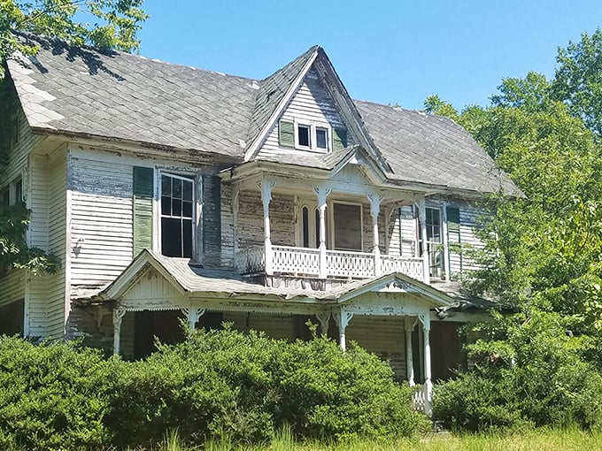The Candler-Linder House whispers tales of bygone eras through its weathered clapboards and Victorian gingerbread trim – a Southern belle awaiting restoration.