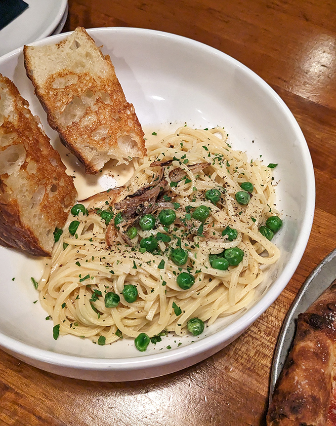 Pasta carbonara that whispers "comfort" with every twirl of your fork. Those peas add perfect pops of sweetness and color.