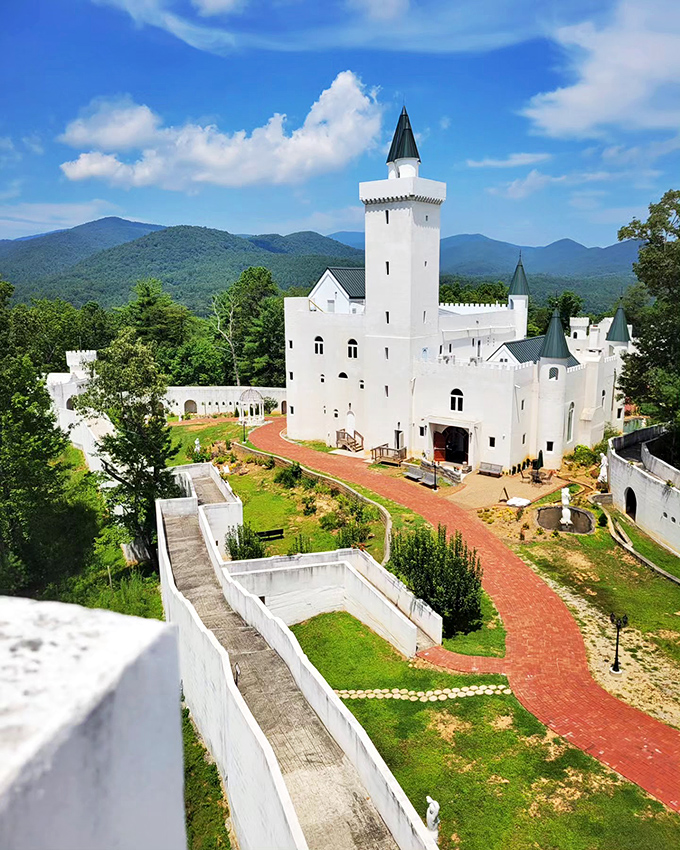 The towering main spire reaches skyward like a medieval exclamation point, announcing its presence to the surrounding mountains.