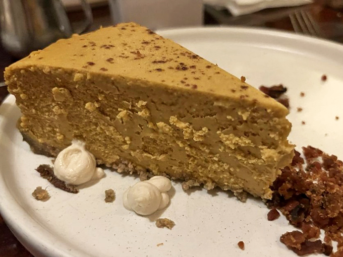 A slice of cheesecake that whispers "take your time with me" &ndash; dense, creamy perfection with just the right amount of sweetness.