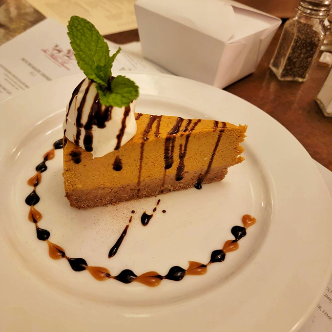 A slice of cheesecake that demands a moment of silence. The artistic sauce drizzles aren't just for show&mdash;they're flavor pathways to dessert nirvana.