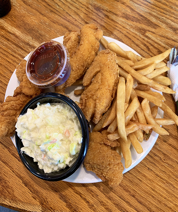 The chicken strip basket: proof that sometimes the simplest pleasures&mdash;perfectly breaded chicken, golden fries, and creamy coleslaw&mdash;are the most satisfying.