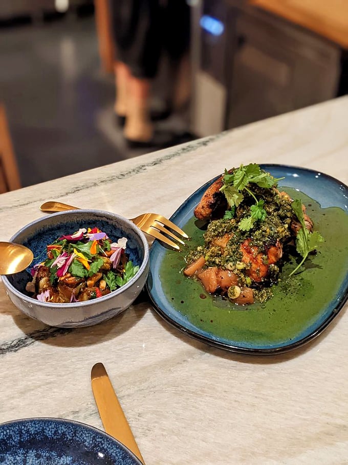 Two plates in perfect harmony&mdash;like a culinary duet that hits all the right notes. Bright herbs and rich sauces create a symphony of Haitian flavors.