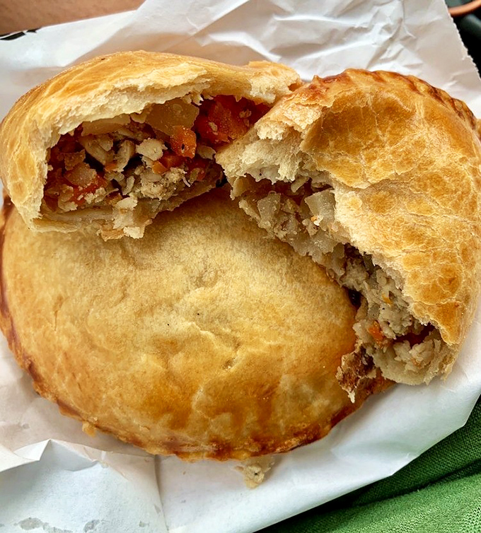 This empanada reveals its savory secrets with one bite. The flaky pastry exterior gives way to a perfectly seasoned filling worth crossing state lines for.