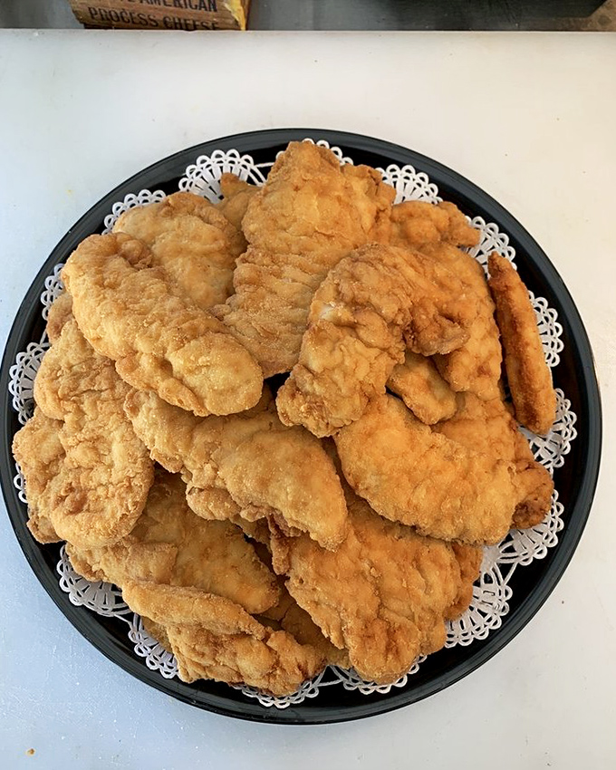 Chicken tenders that could make a vegetarian weep. Golden-brown perfection arranged on a doily&mdash;because even comfort food deserves a proper presentation.