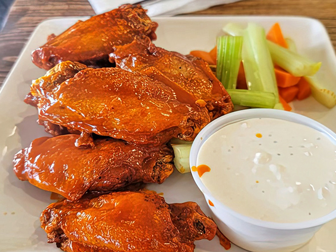 Buffalo wings that arrive glistening like edible jewelry, ready to make your taste buds stand up and salute.
