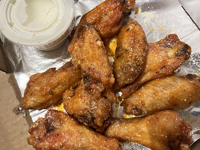 Wings that achieve that mythical balance of crispy exterior and juicy interior—the kind that make you wonder why you ever bother with boneless.