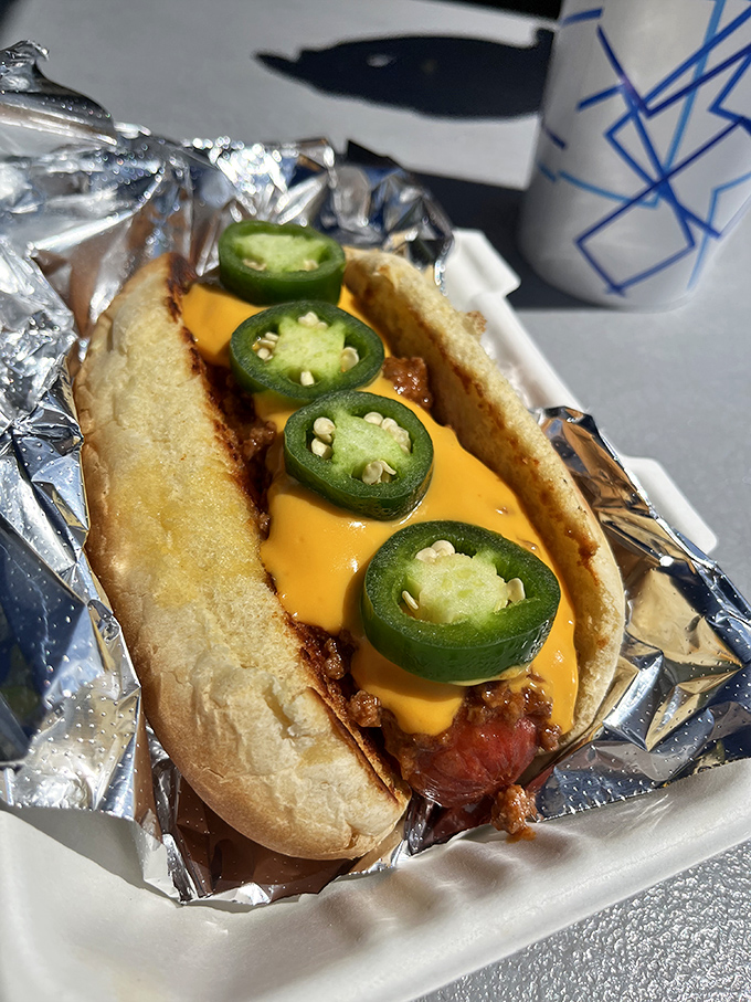The chili cheese dog arrives loaded with jalape&ntilde;os, proving paradise sometimes comes with proper heat.
