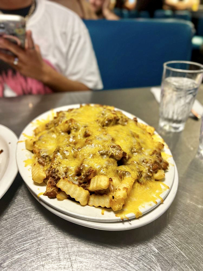 Chili cheese fries that don't apologize for what they are: a magnificent mountain of crispy potatoes buried under an avalanche of melted cheese.