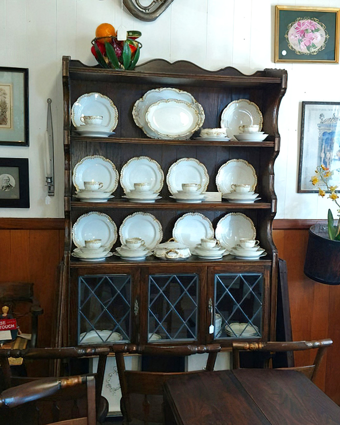Not your average dining set display. This china cabinet has more personality than most modern furniture showrooms combined.