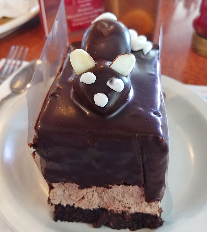 Chocolate mousse cake with a mouse decoration that's almost too cute to eat. Almost. The layers promise a textural journey from dense to dreamy.