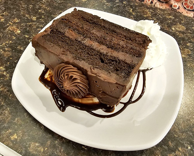 A chocolate cake so rich it probably has its own offshore bank account. The frosting-to-cake ratio here deserves a standing ovation.