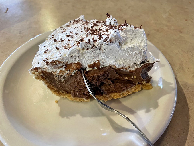 Chocolate cream pie topped with a cloud of whipped cream. One bite and you'll understand why there's a sign that says "Eat Pie First."