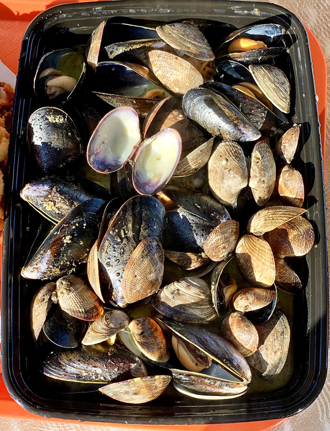 A black container of oceanic jewels&mdash;these clams and mussels are nature's perfect appetizer, no silverware required.