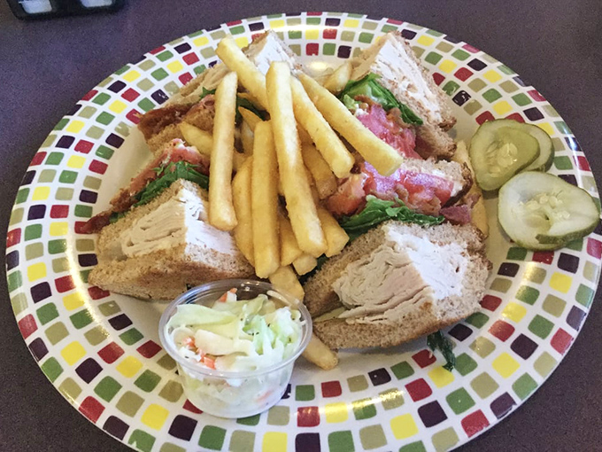 The club sandwich&mdash;architecture you can eat! Layers of goodness stacked between toast with crispy fries standing guard.