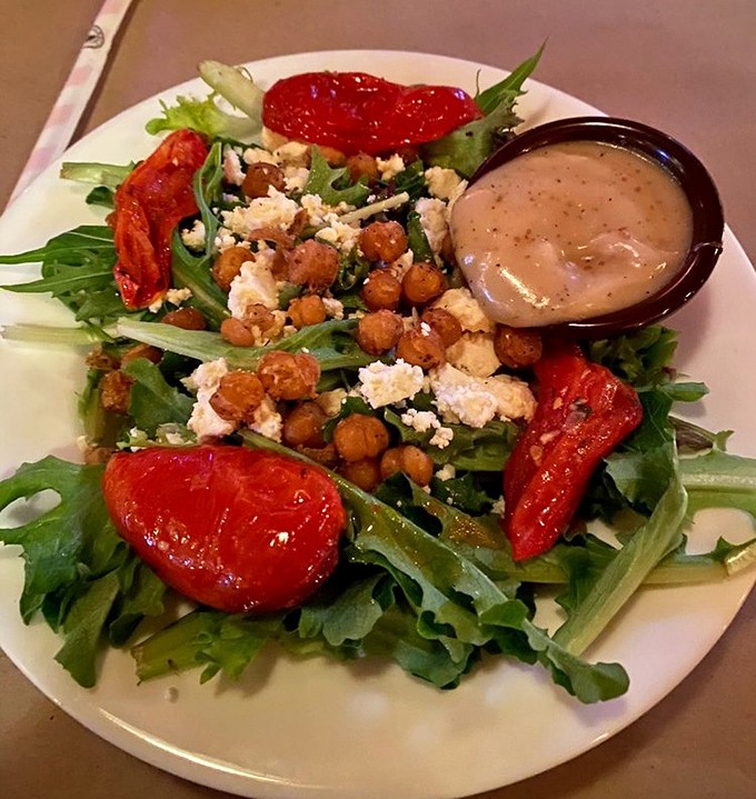 Even the salads demand respect here &ndash; wood-fired tomatoes, crispy chickpeas, and goat cheese prove that "eating light" doesn't mean sacrificing flavor.