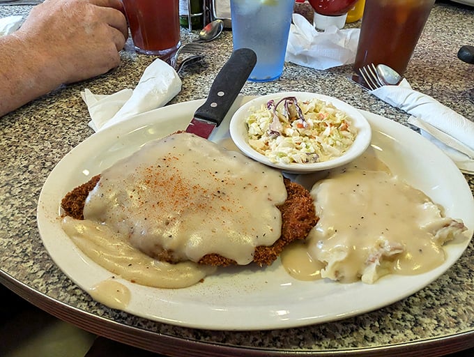 Country fried steak swimming in gravy so good you'll want to write poetry about it. Comfort food that hugs you from the inside. 