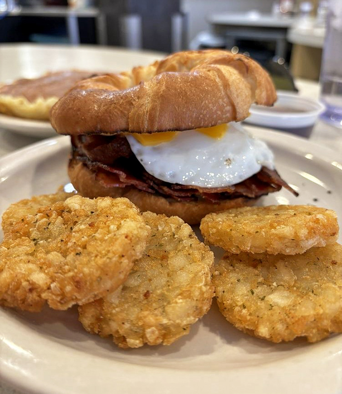 This breakfast sandwich on a croissant with those golden potato cakes is what morning dreams are made of.