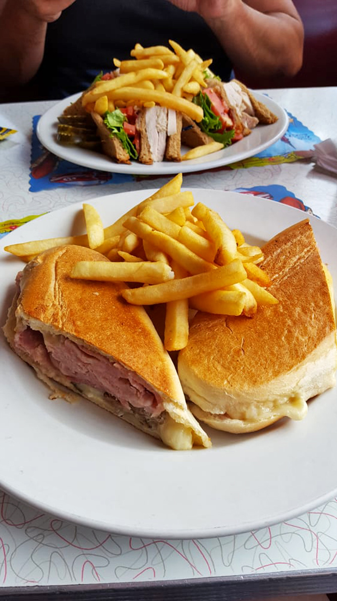 The Cuban sandwich: Miami's edible ambassador. Pressed to perfection with a side of fries that look like they're auditioning for a food commercial.