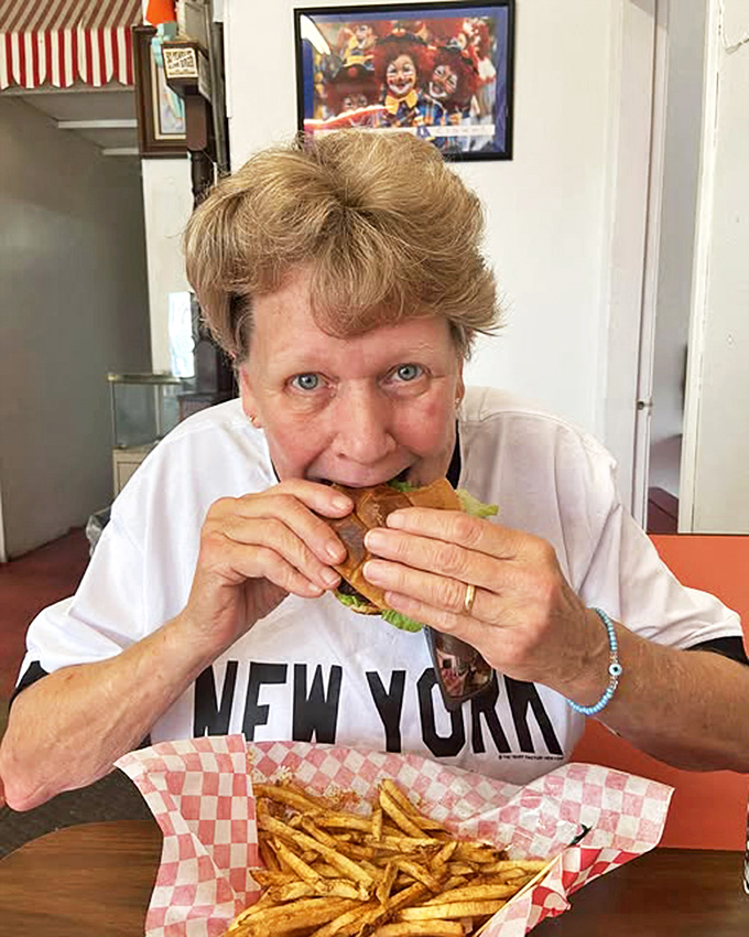 The satisfied smile of someone who just discovered their new favorite burger joint &ndash; priceless and contagious.