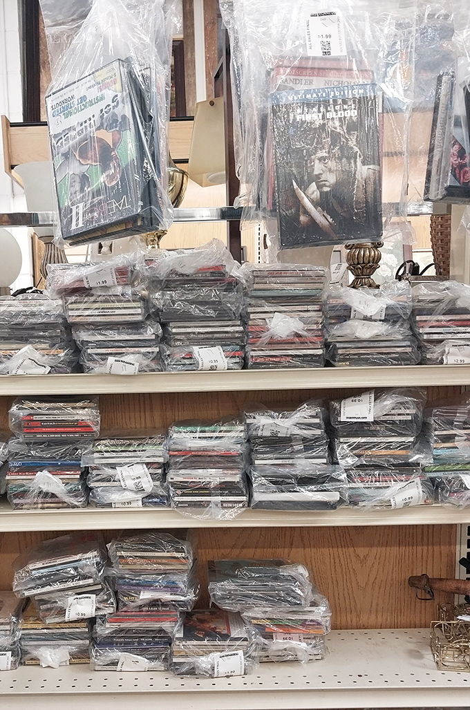 Wrapped DVDs and CDs create a time capsule of entertainment history, where forgotten blockbusters and one-hit wonders await rediscovery.