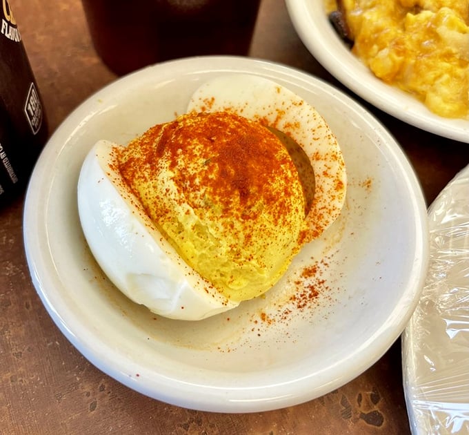 This deviled egg, dusted with paprika like a tiny food supermodel, proves that sometimes the simplest dishes require the most respect.
