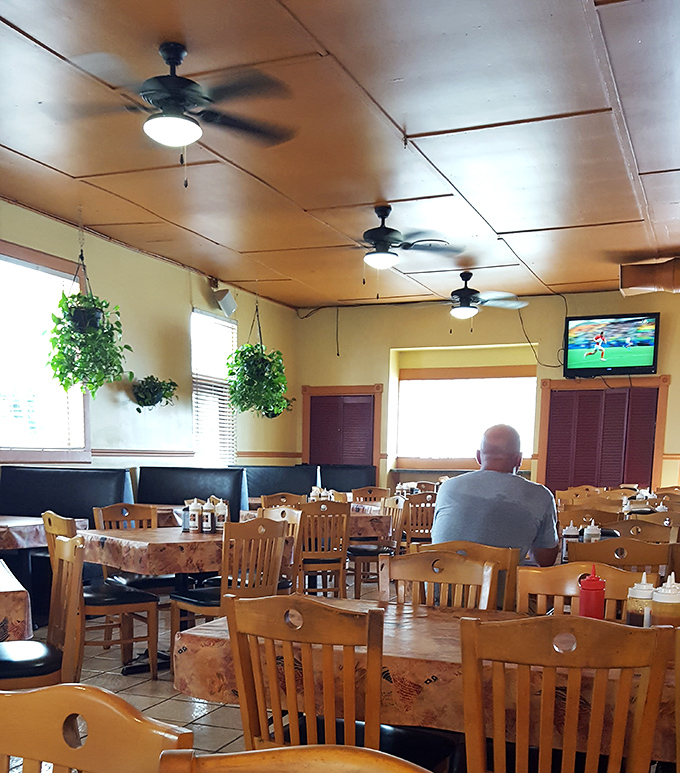 Ceiling fans lazily spin above wooden chairs and tables, creating that "time slows down here" atmosphere that's increasingly rare in our world.